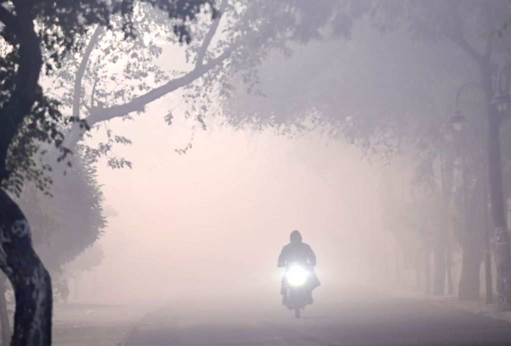 Commuters Ride Through Fog