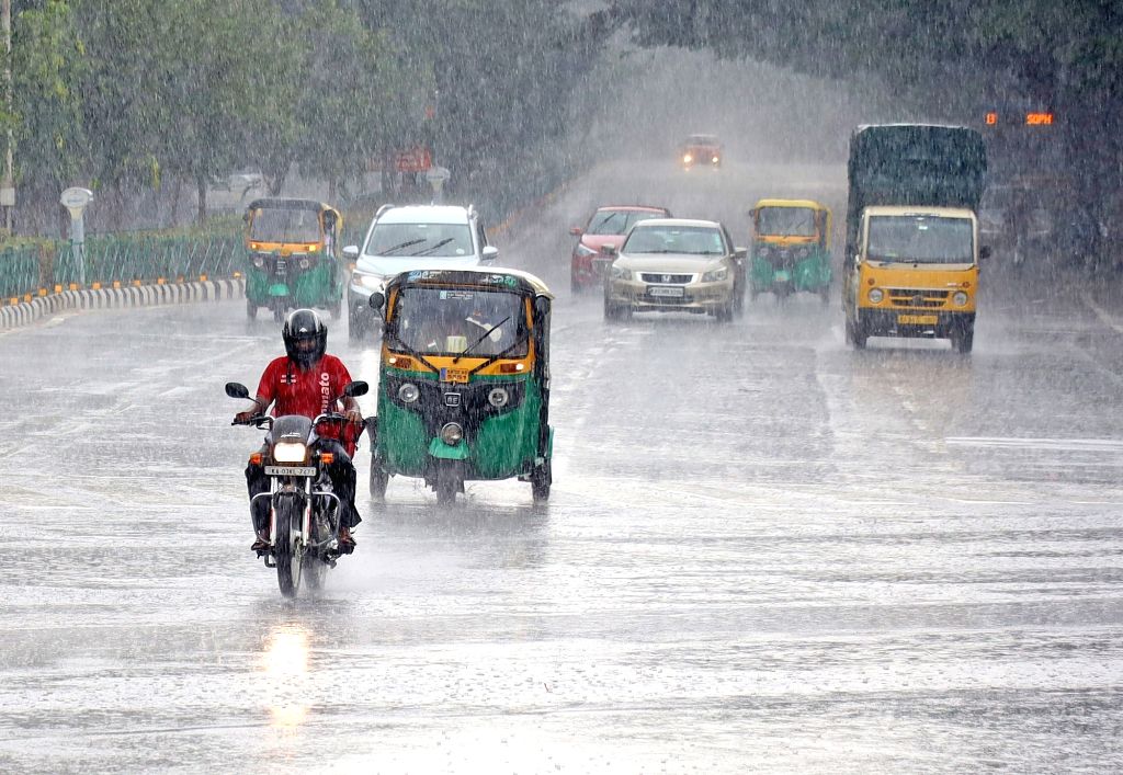 Bengaluru: Commuters wade through heavy rain at Cubbon road