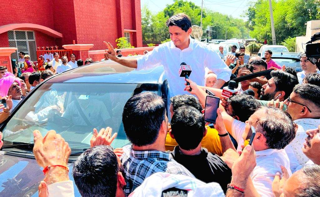 Congress leader Deependra Hooda shows his ink-marked finger