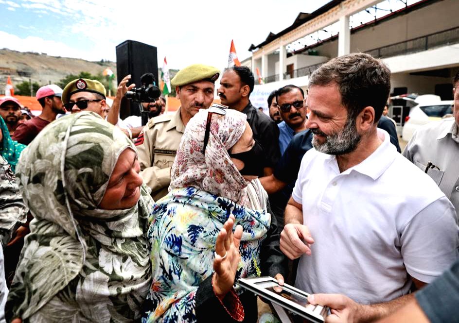 Congress leader Rahul Gandhi waves at supporters during a public meeting