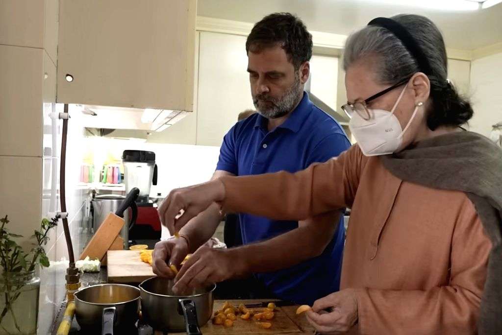 Congress leaders Sonia Gandhi and Rahul Gandhi work in the kitchen to ...