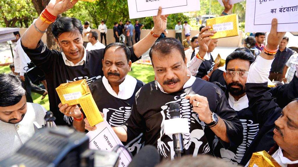 Congress MLAs protest with gold bricks