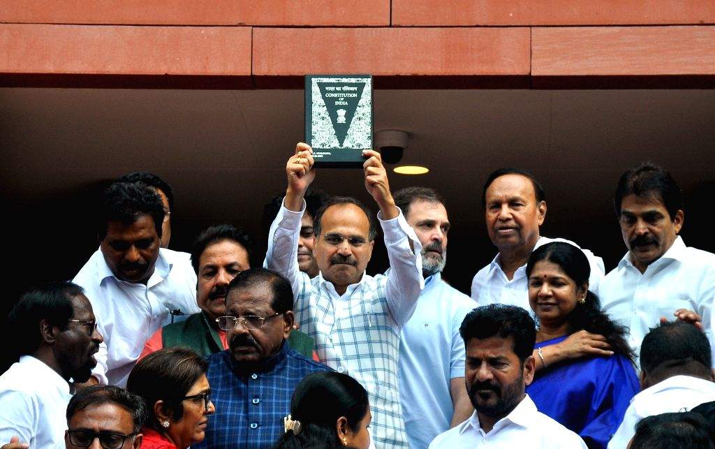 Congress MP Adhir Ranjan Chowdhury, holding the Constitution of India