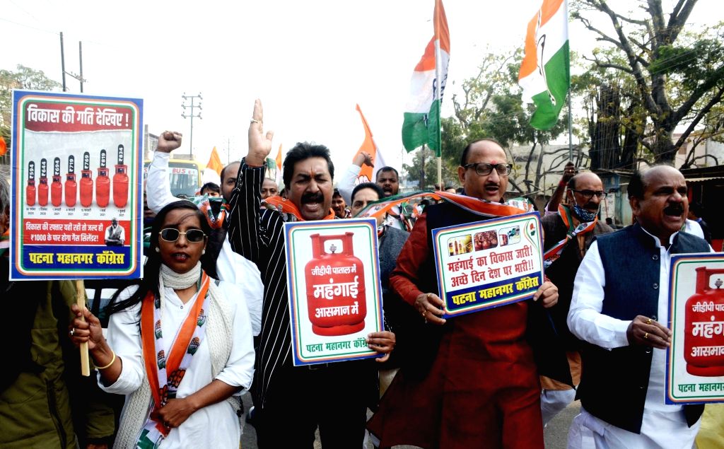 Congress party workers raise slogans during a protest march against ...
