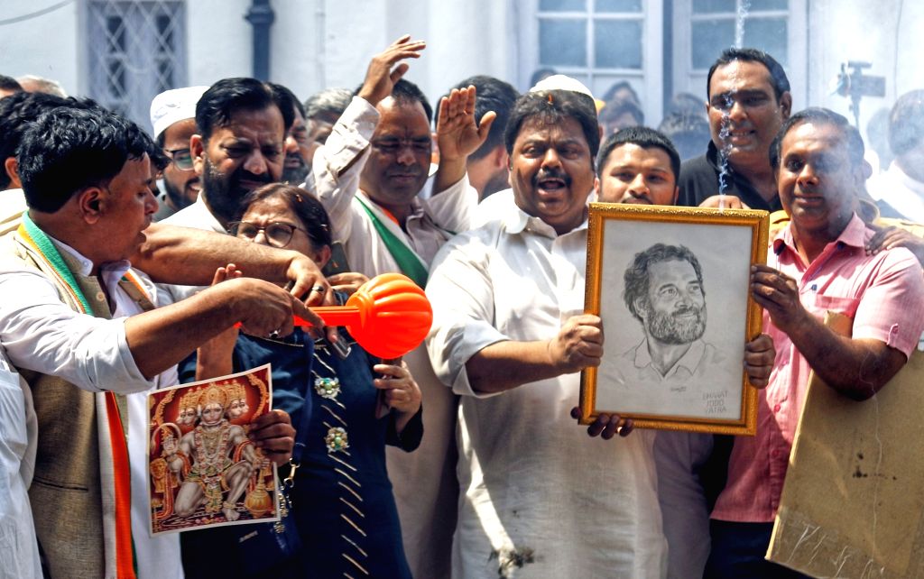 Congress workers celebrate at the AICC HQ after the party's decisive ...