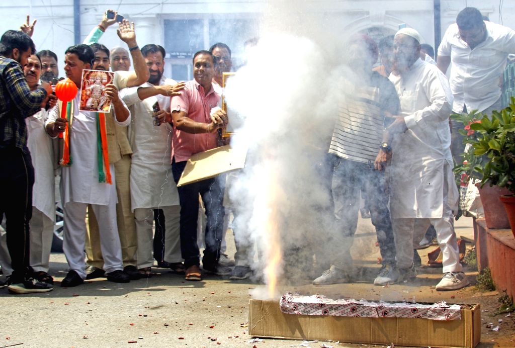 Congress workers celebrate at the AICC HQ after the party's decisive ...