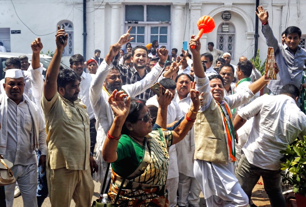 Congress workers celebrate at the AICC HQ after the party's decisive ...