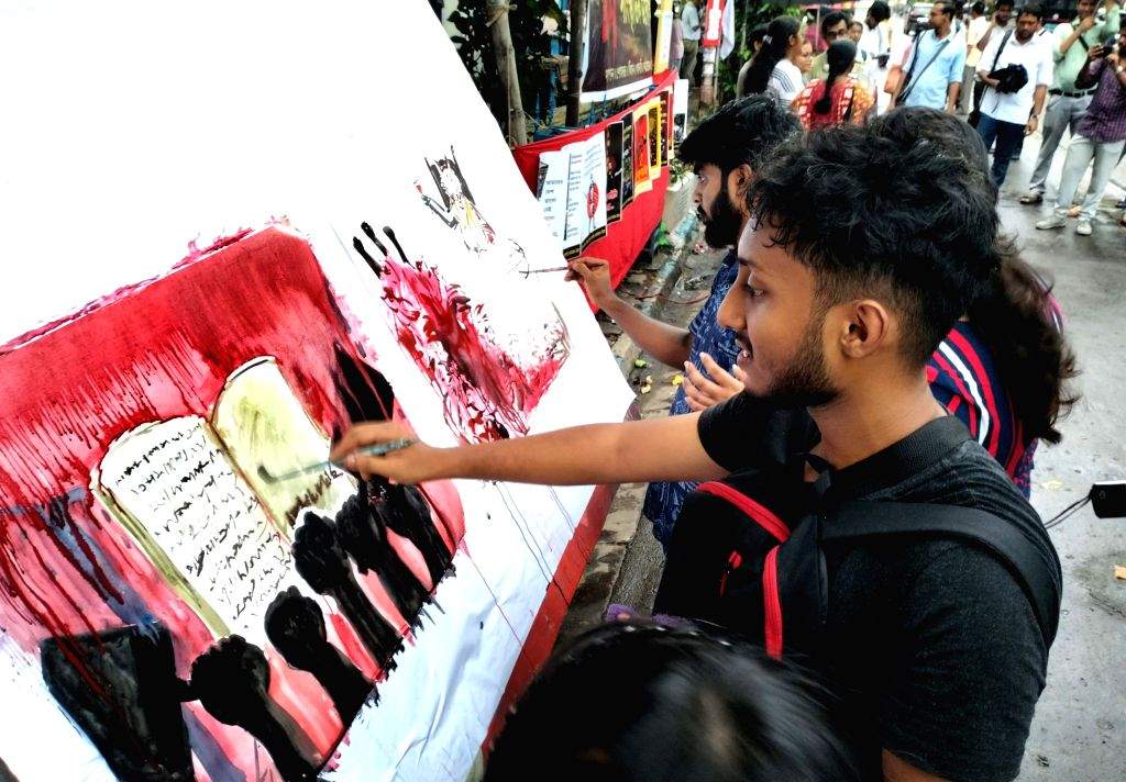 Culcutta University students draw a painting as they participate in a ...