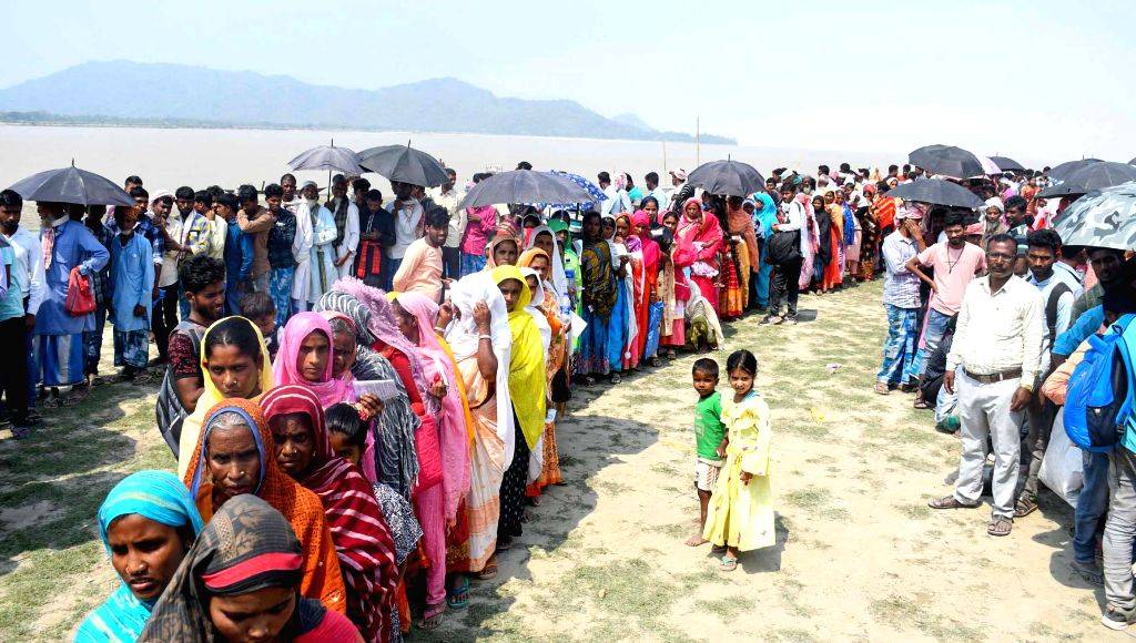 Darrang : People cross the Brahmaputra river in a boat to reach a ...