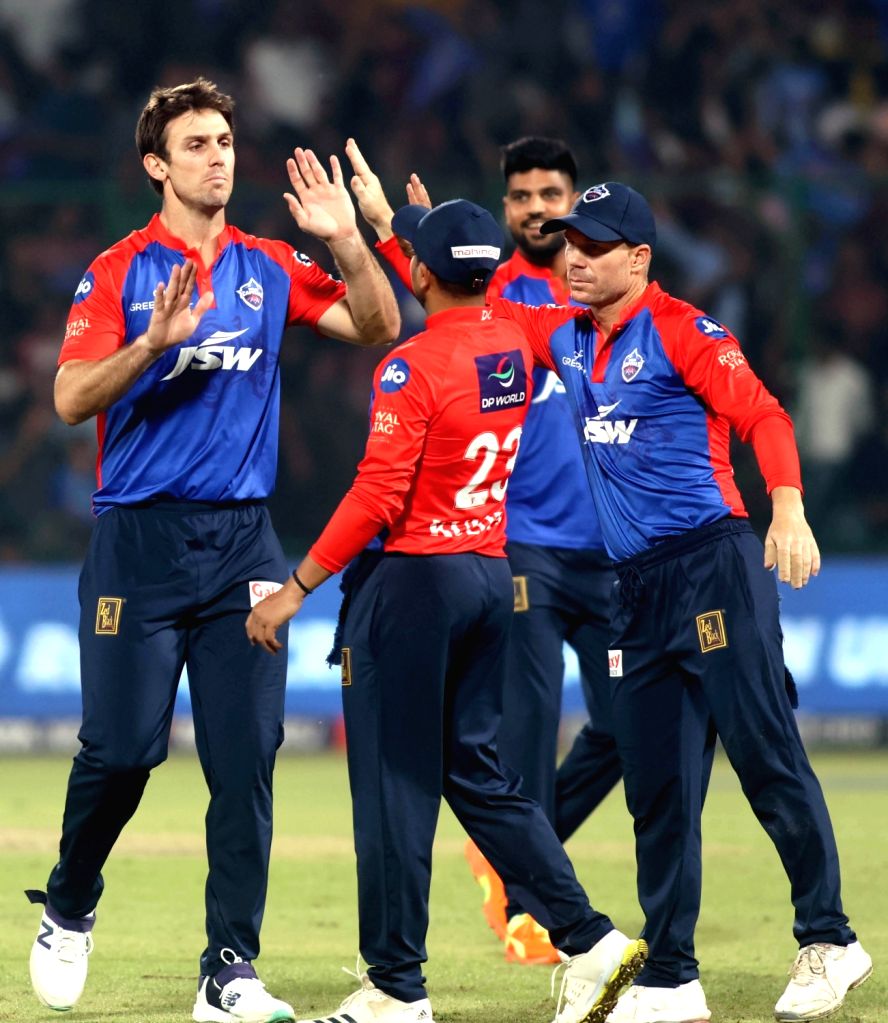 DC bowler Mitchell Marsh along with teammates celebrate the dismissal ...