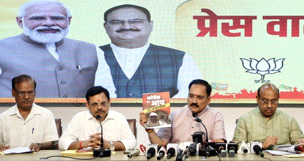 Delhi BJP President Virendra Sachdeva with Vijendra Gupta during a ...