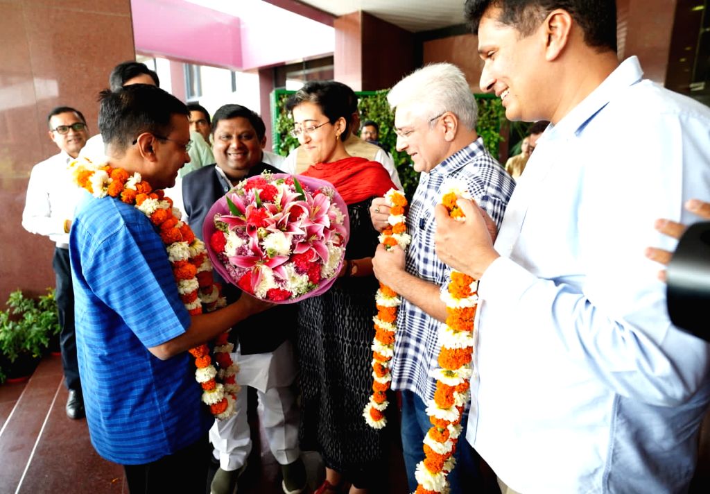 Delhi Cabinet Ministers greet Chief Minister Arvind Kejriwal as he ...