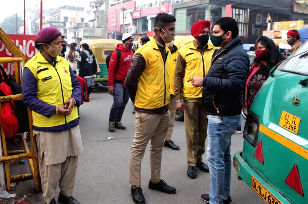 Delhi Civil Defence workers allow fully vaccinated people to enter ...