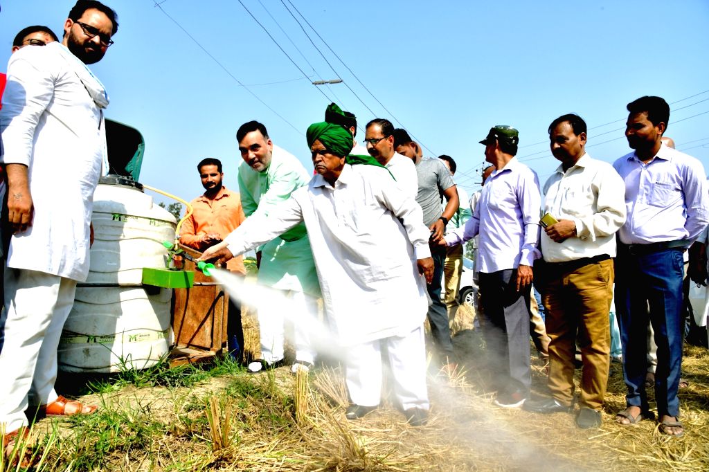 Delhi Environment Minister Gopal Rai sprays bio de-composer for stubble