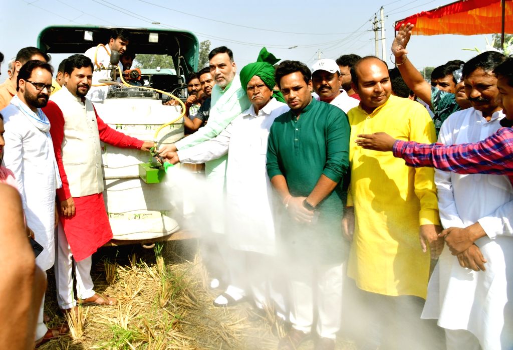 Delhi Environment Minister Gopal Rai sprays bio de-composer for stubble