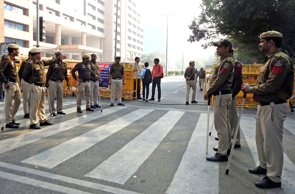 Delhi police personnel check commuters outside CBI headquarters