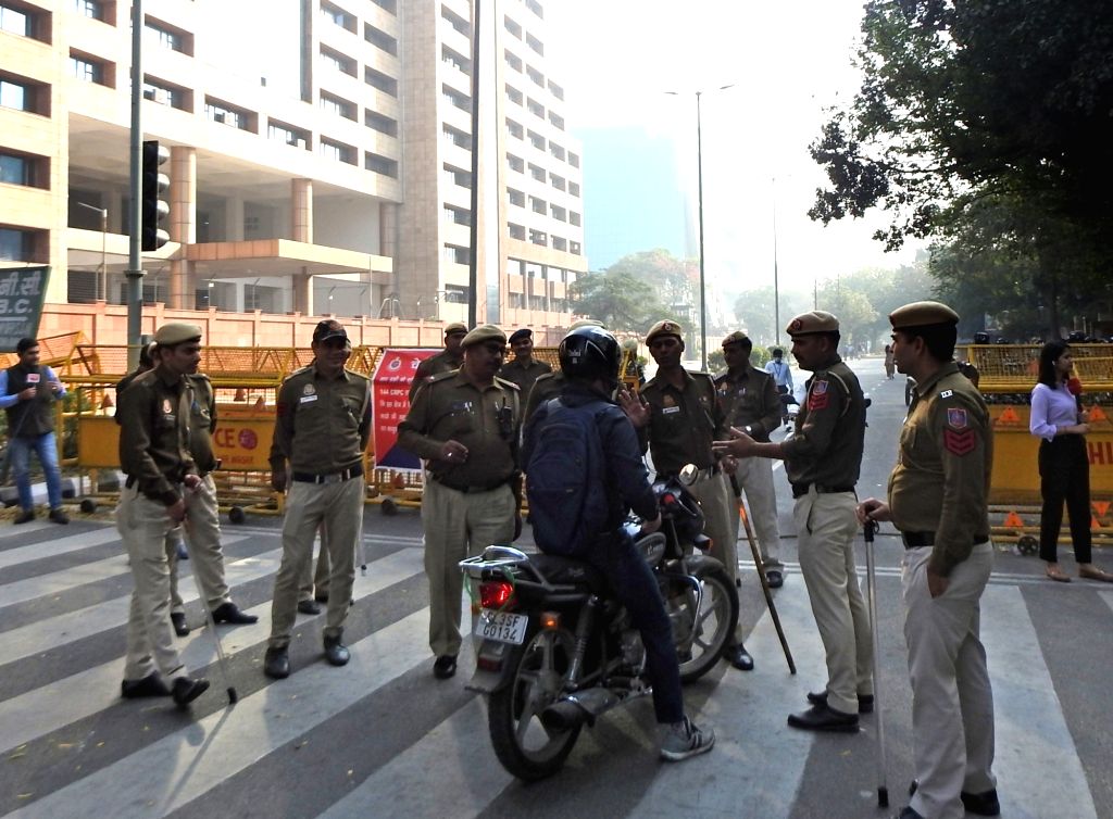 Delhi police personnel check commuters outside CBI headquarters