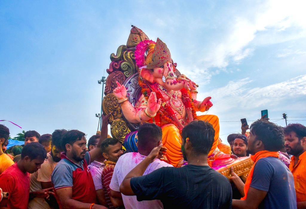 Devotee Carries Lord Ganesha Idol for Immersion