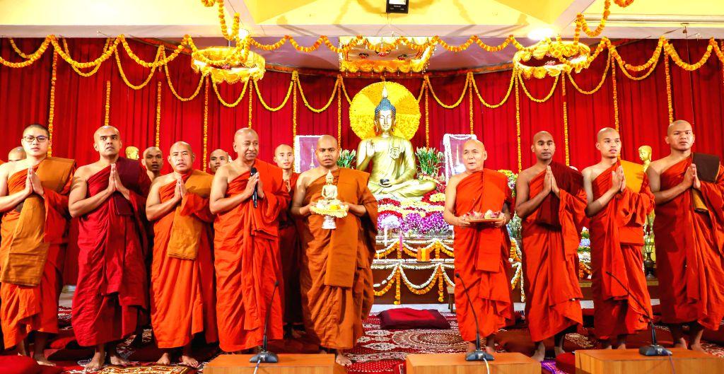 Devotees and monks observe Buddha Purnima