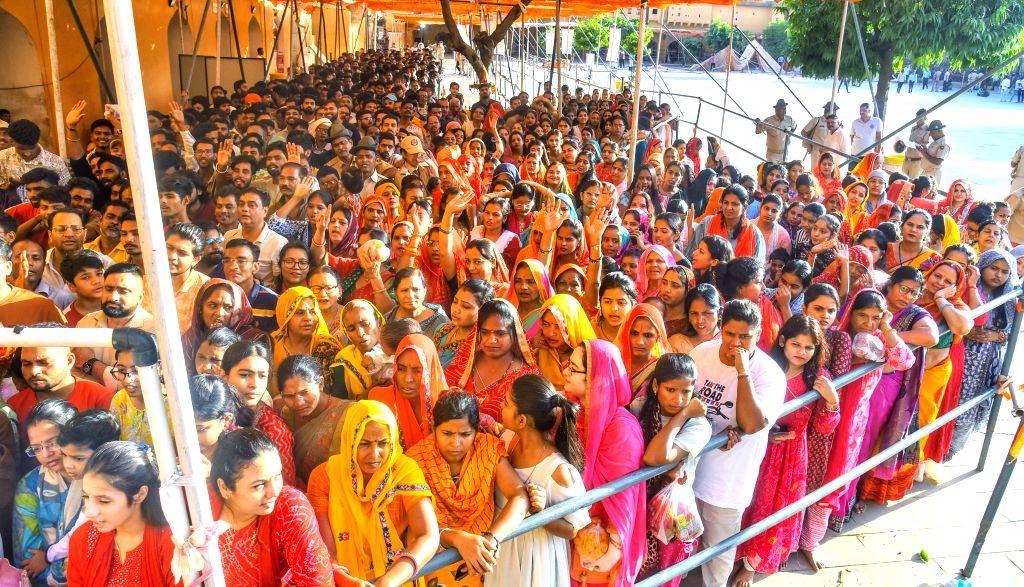 Devotees arrive to offer prayers at the Shila Mata Temple