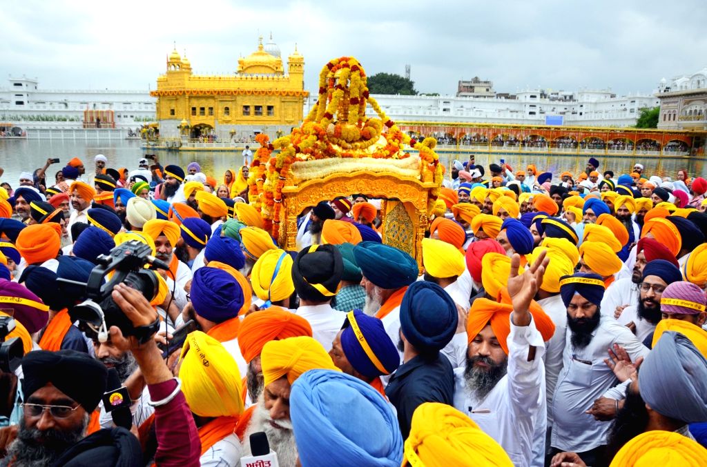 Devotees carry the Guru Granth Sahib during a religious procession