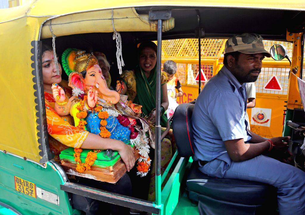 Devotees carrying an idol of Lord Ganesha for immersion