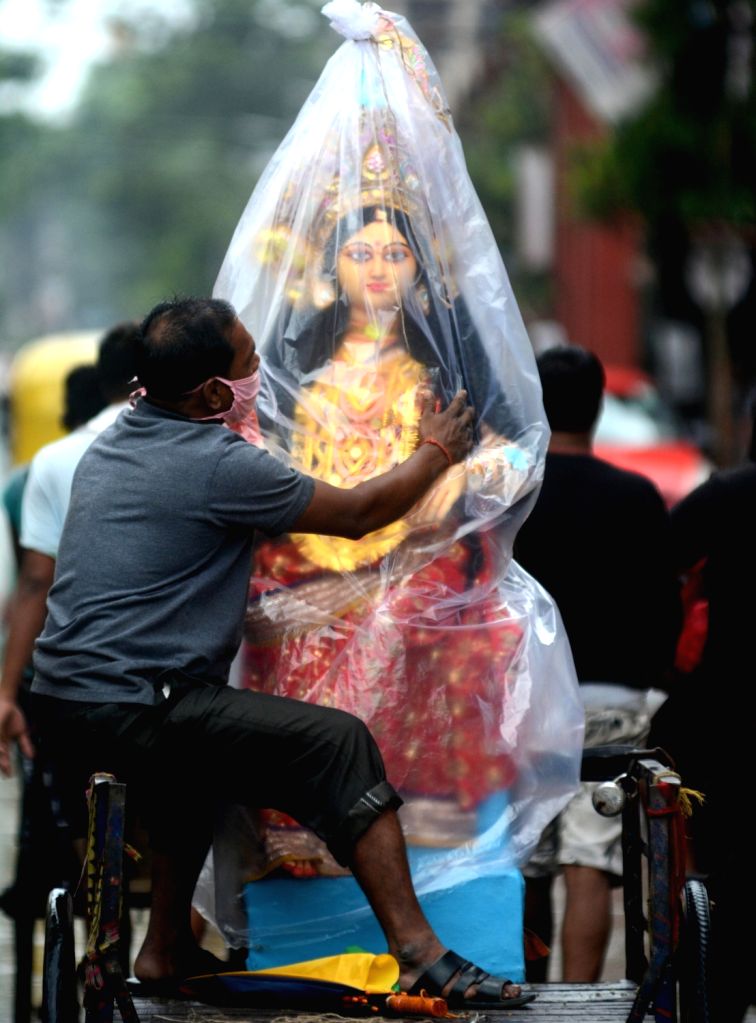 Kolkata :Devotees carrying Idols of Goddess Laxmi with plastics cover ...