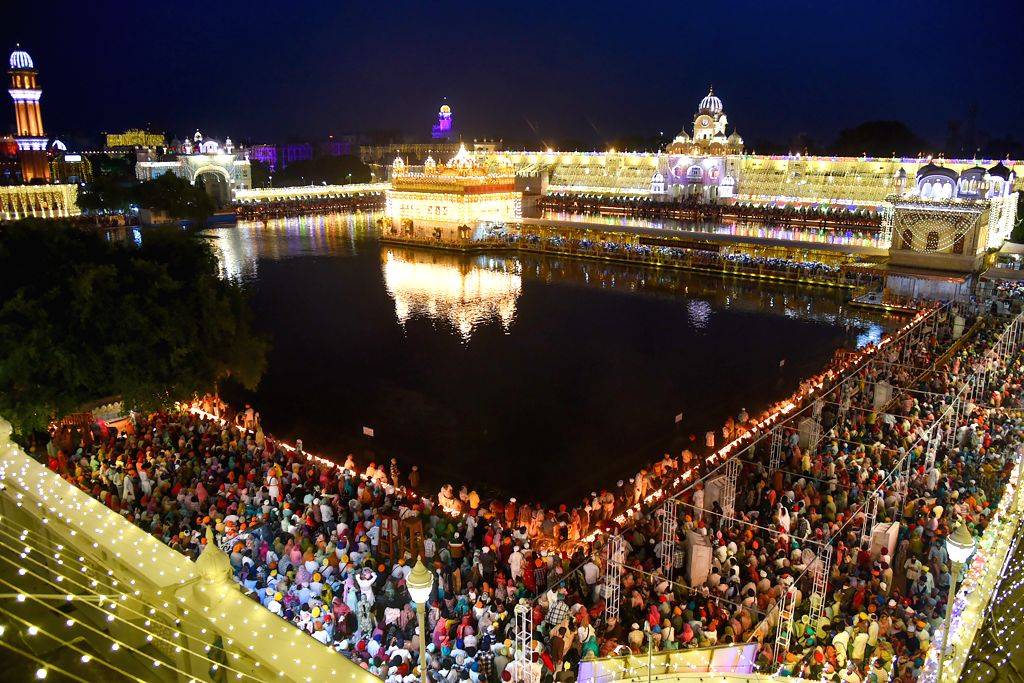 Devotees Light Candles At Golden Temple