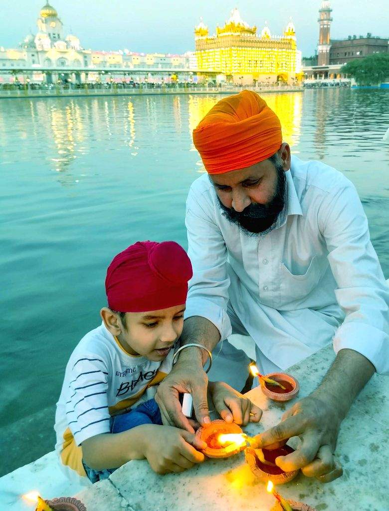 Devotees Light Up Diyas at Golden Temple