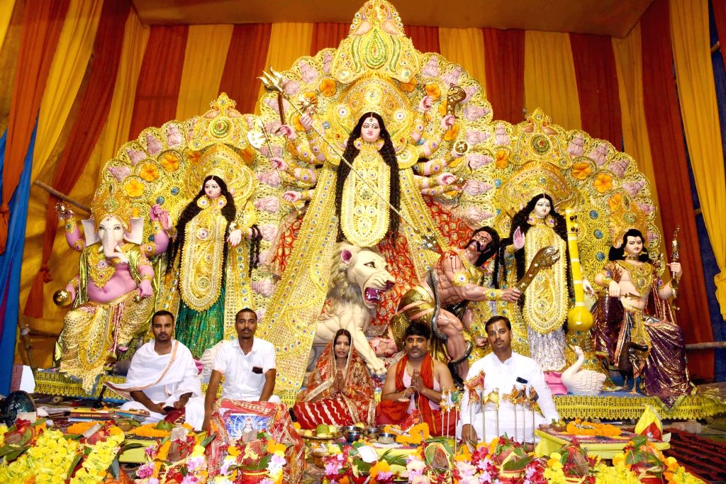 Devotees offer prayers to an idol of Goddess Durga