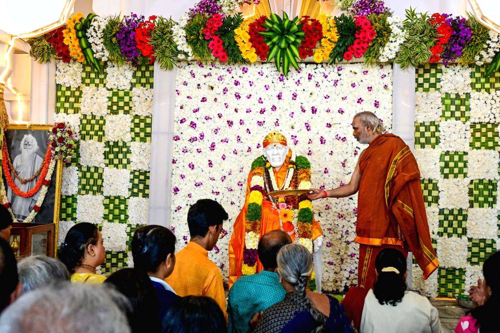 Devotees offer prayers to Sai Baba