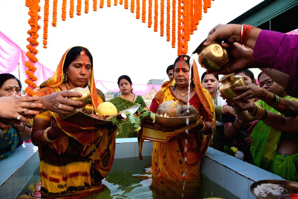 : Patna:Devotees perform rituals during Chhat Puja at a makeshift pool.