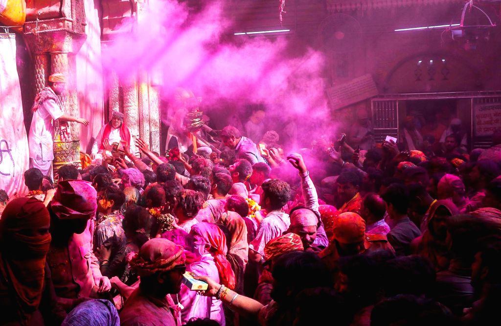 : Vrindavan : Devotees play with colours ahead of the festival of Holi ...
