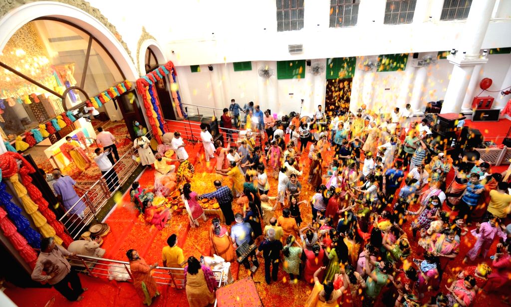 Devotees play with flower petals called 'Phool Dol' or Holi ...