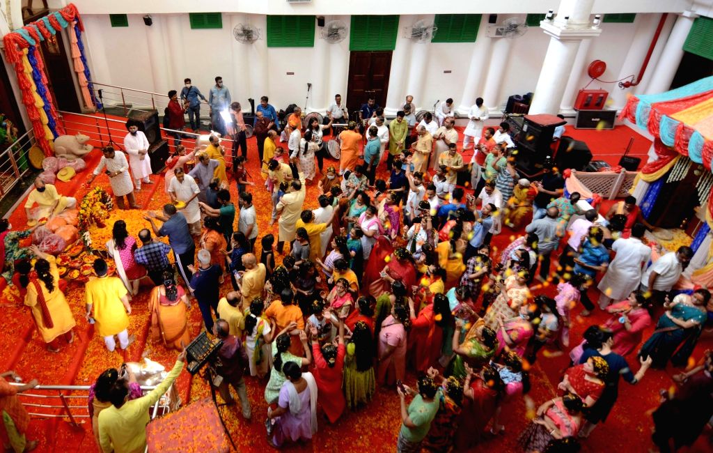 Devotees play with flower petals called 'Phool Dol' or Holi ...