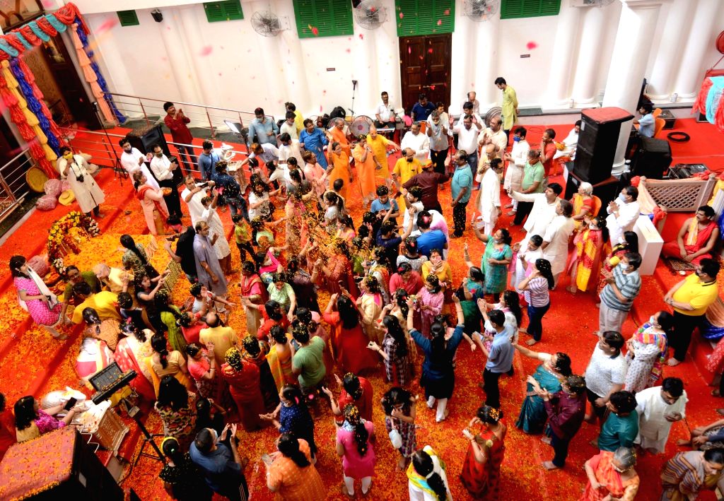 Devotees play with flower petals called 'Phool Dol' or Holi ...