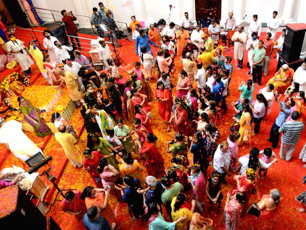 Devotees play with flower petals called 'Phool Dol' or Holi ...