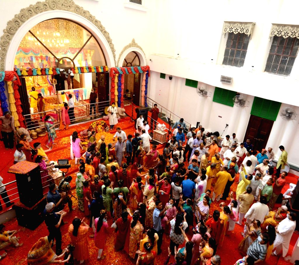 Devotees play with flower petals called 'Phool Dol' or Holi ...