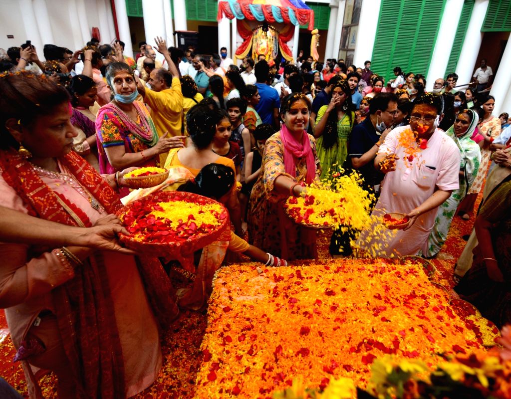 Devotees play with flower petals called 'Phool Dol' or Holi ...