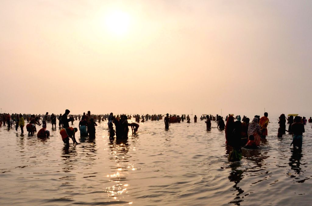 Devotees take a holy dip in Ganga river at the Gangasagar Mela on the ...