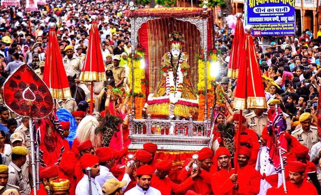 Devotees take out a religious procession on the occasion of Teej ...