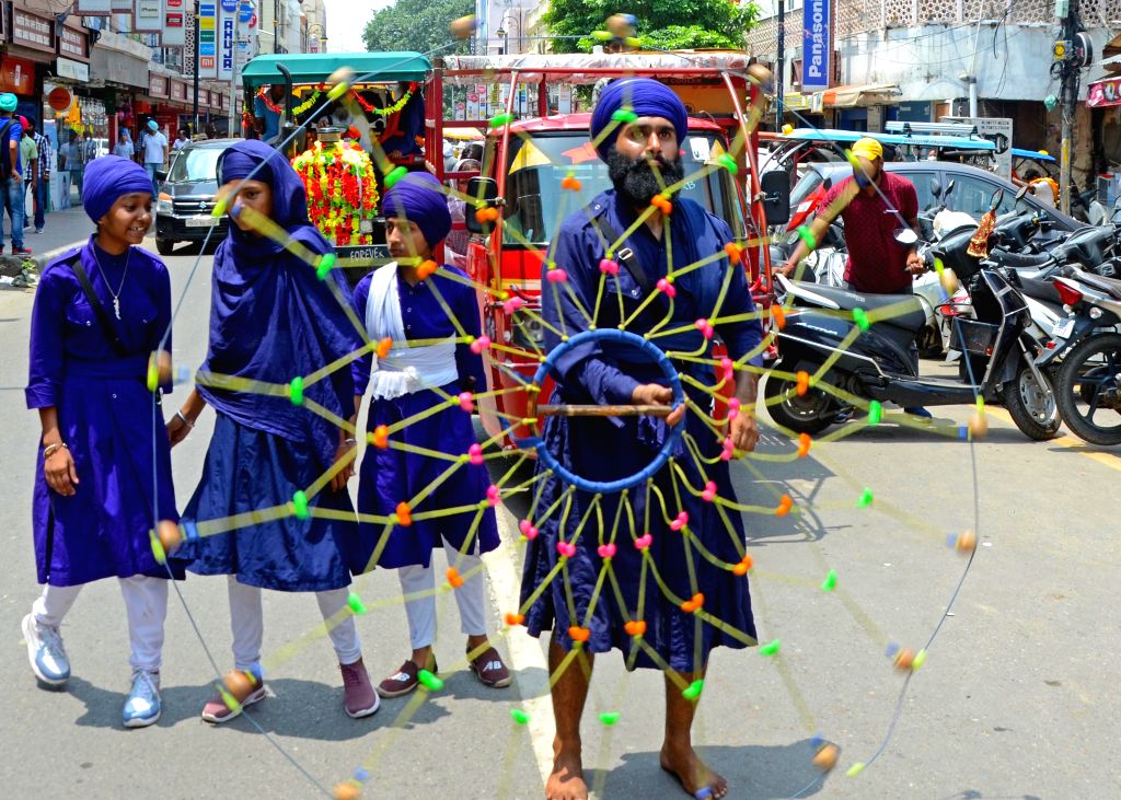 Devotees take part in a nagar kirtan procession during the Miri Piri ...