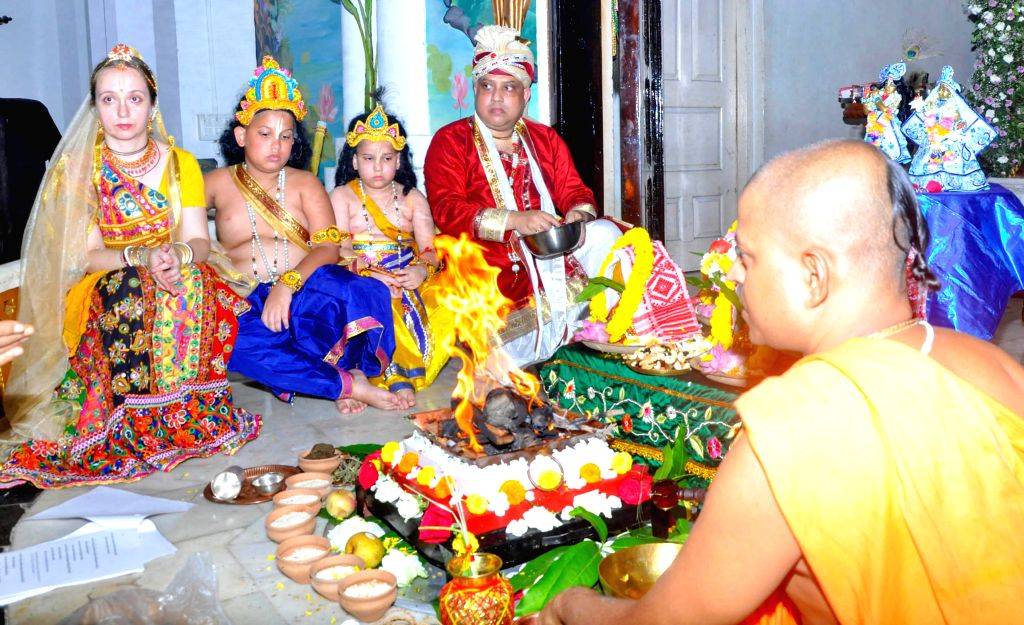 Devotees take part in a 'pooja' at the ISKCON temple on the occasion of ...