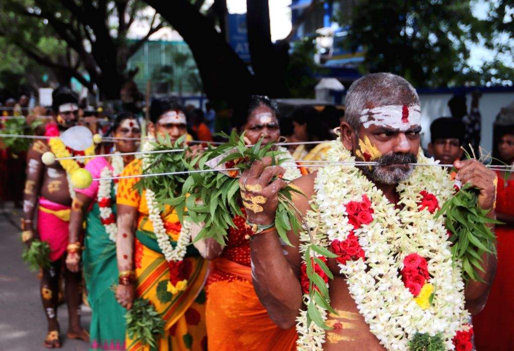 Devotees take part in religious procession during the auspicious Tamil ...