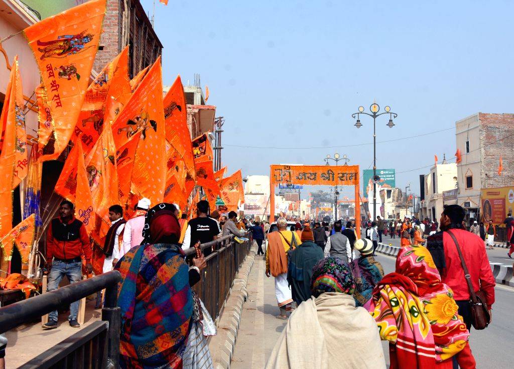 Devotees walk on a road ahead of the Ram temple consecration ceremony