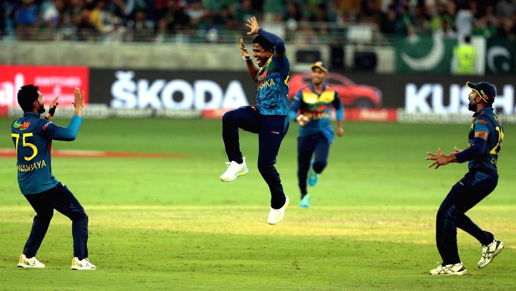 :Dubai: Sri Lanka's Pramod Madushan celebrates a dismissal