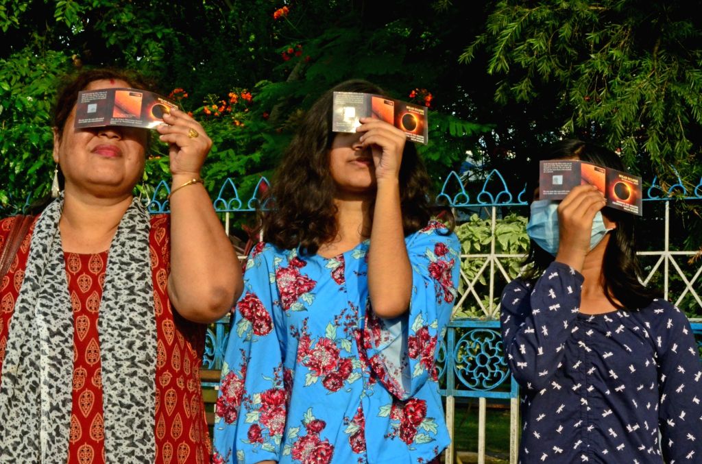 Enthusiasts try to watch a partial solar eclipse through the Sun filter