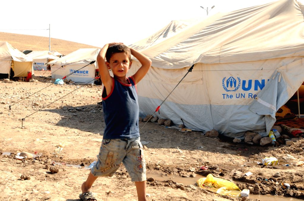 A Syrian boy walks at Kawergost Refugee Camp, some 50 km north of Erbil