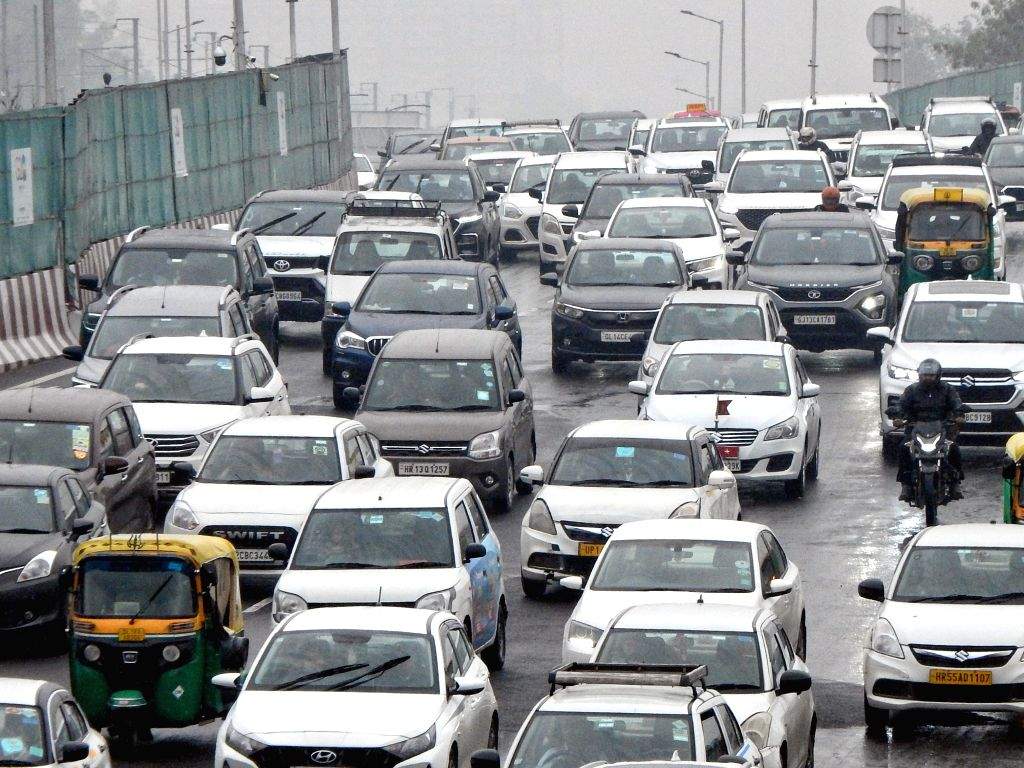 ew Delhi: Vehicles navigate through heavy traffic amidst light rainfall