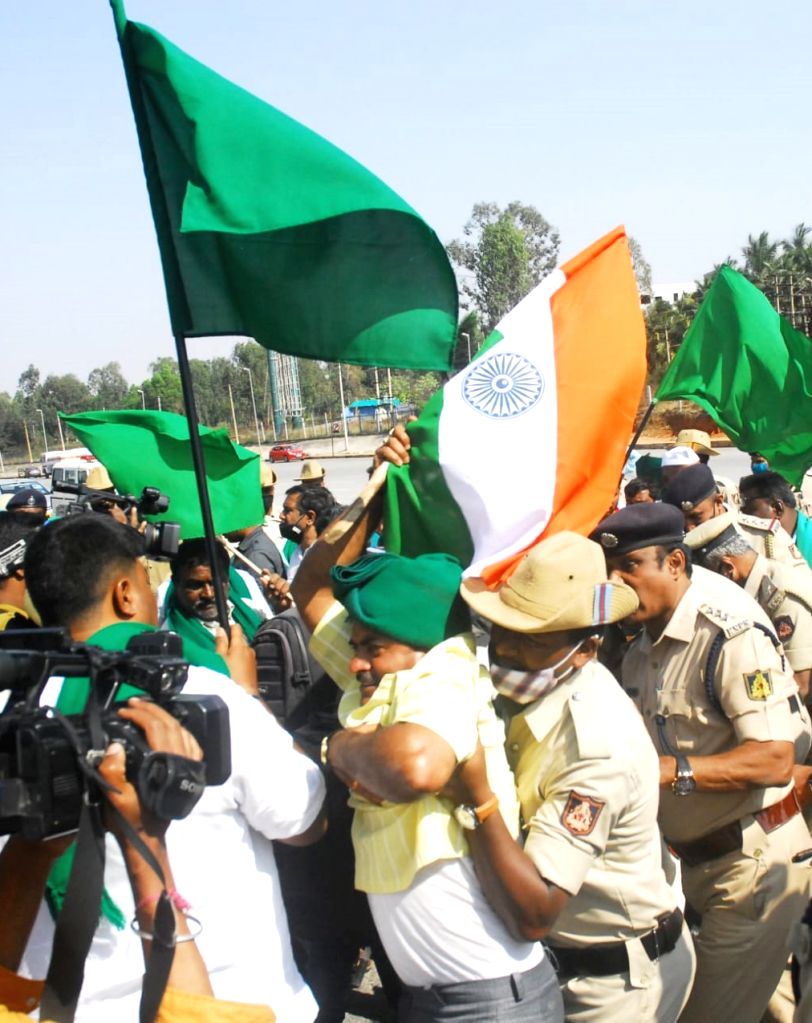 Farmers being detained by Police personnel during their protest at ...